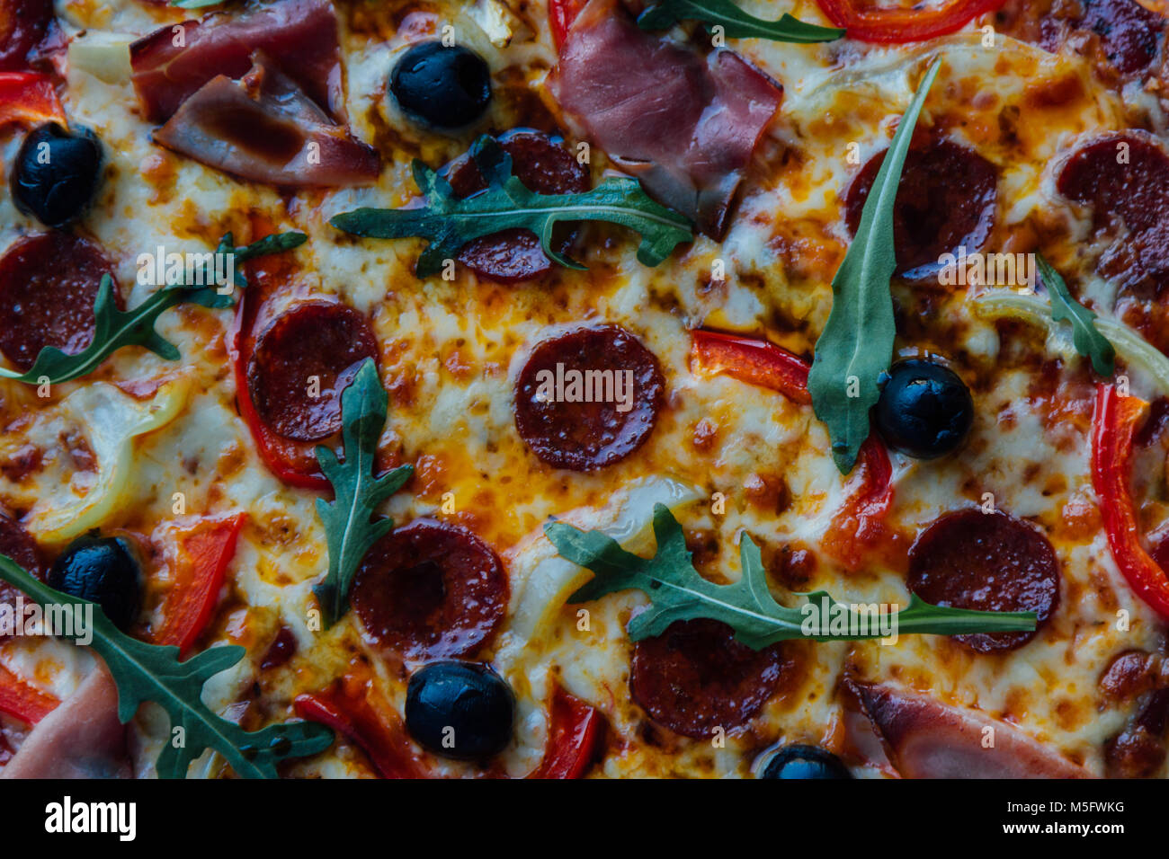 fresh tasty rustic sausage pizza closeup top view Stock Photo - Alamy