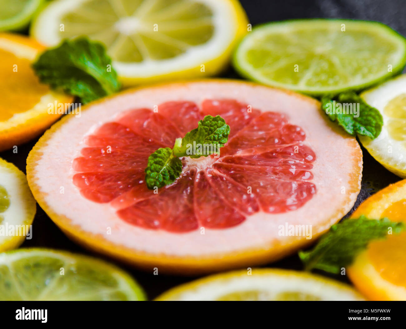 sliced color fresh juicy healthy citrus fruits Stock Photo - Alamy