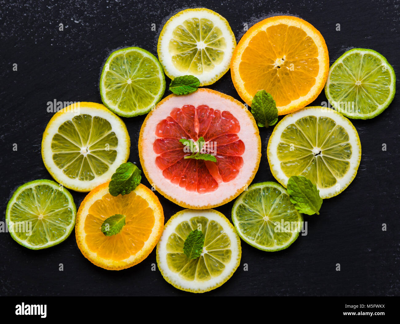sliced color fresh juicy healthy citrus fruits Stock Photo - Alamy