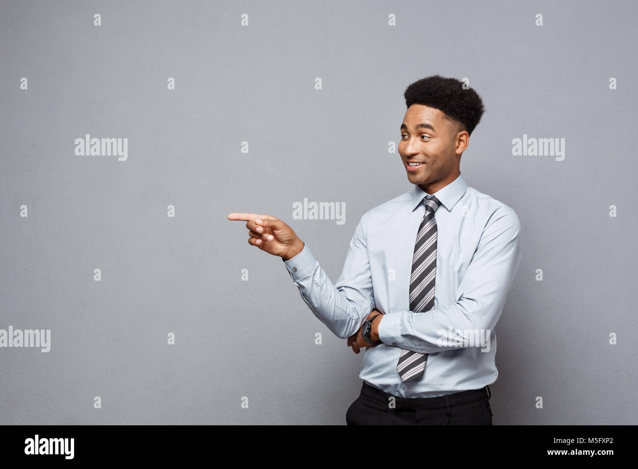 Business Concept - Confident thoughtful young African American pointing ...