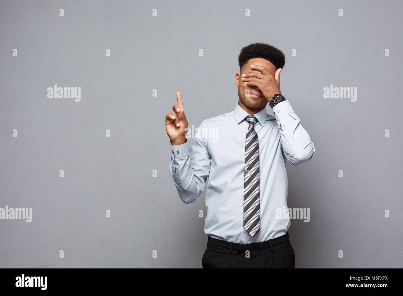 Business Concept - Confident thoughtful young African American pointing ...