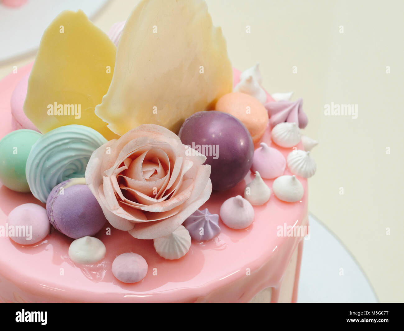 Modern French mousse cake with pink mirror glaze decorated with ...