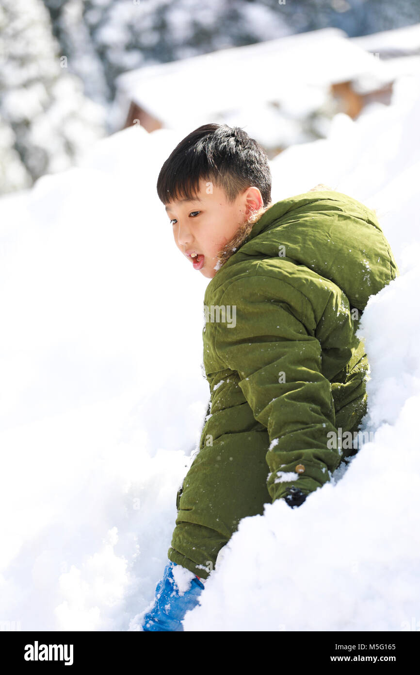 boy lay down on the snow and enjoy snow in the winter Stock Photo - Alamy