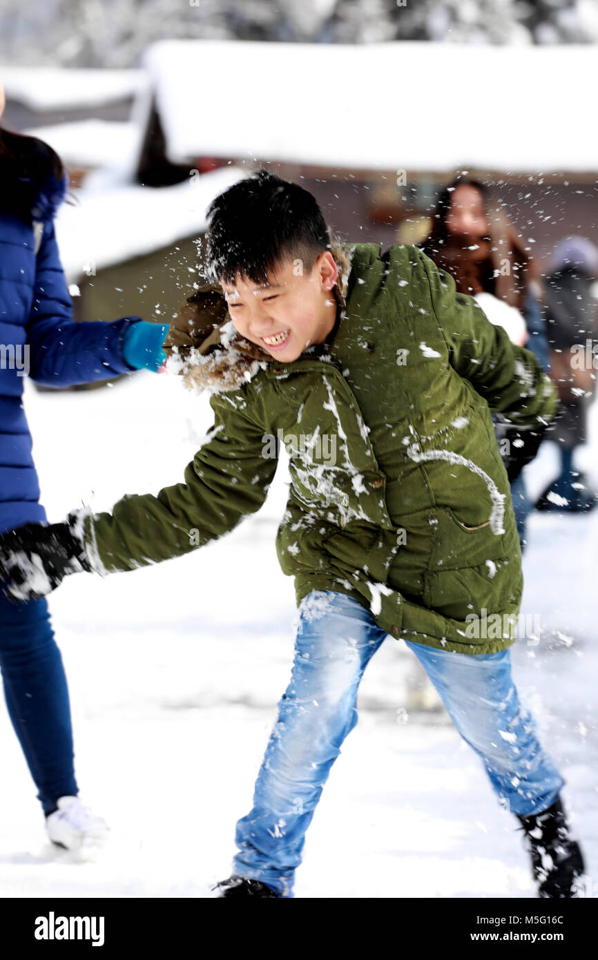 boy lay down on the snow and enjoy snow in the winter Stock Photo - Alamy
