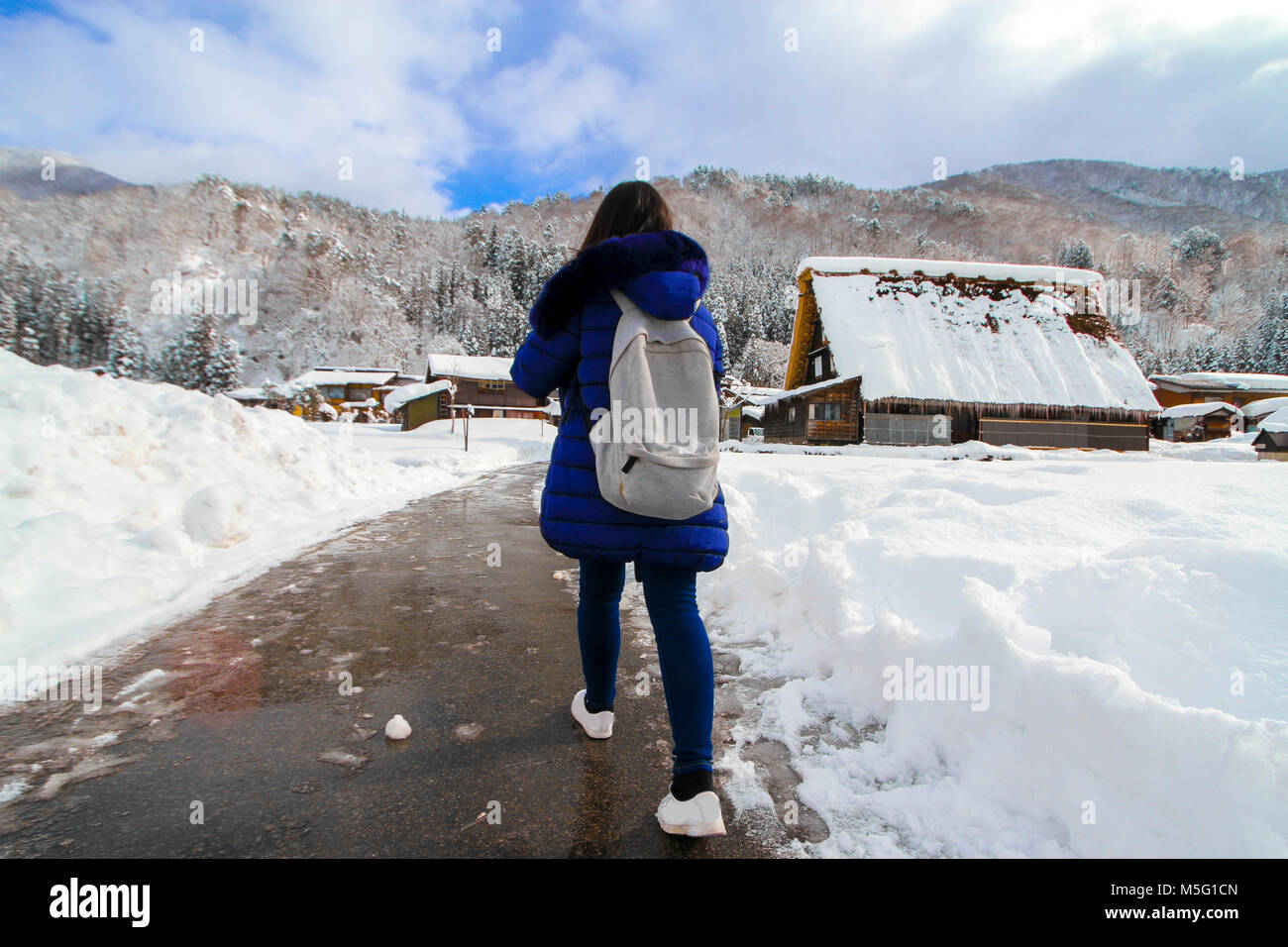 girl walking alone on the snow Stock Photo - Alamy