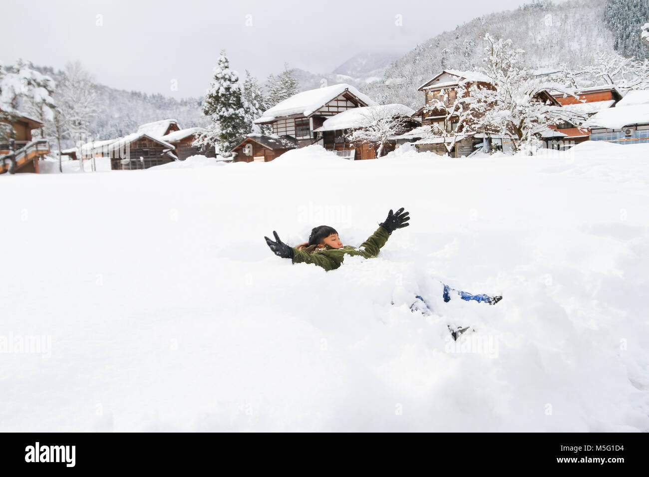 boy lay down on the snow and enjoy snow in the winter Stock Photo - Alamy