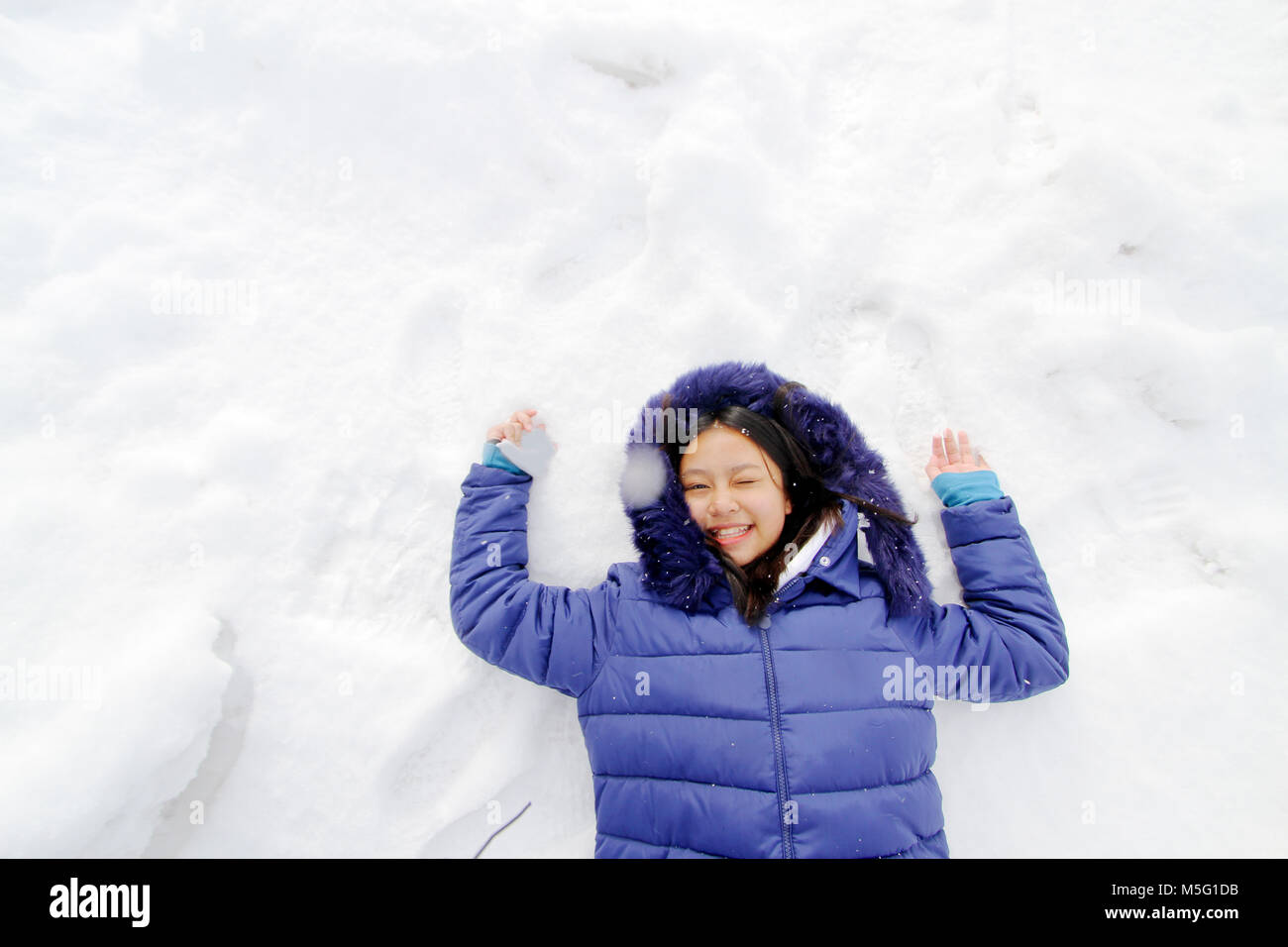 Adult laying down on snow hi-res stock photography and images - Alamy