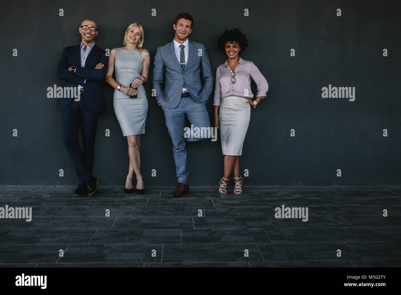 Full length portrait of multiracial team of business professionals ...