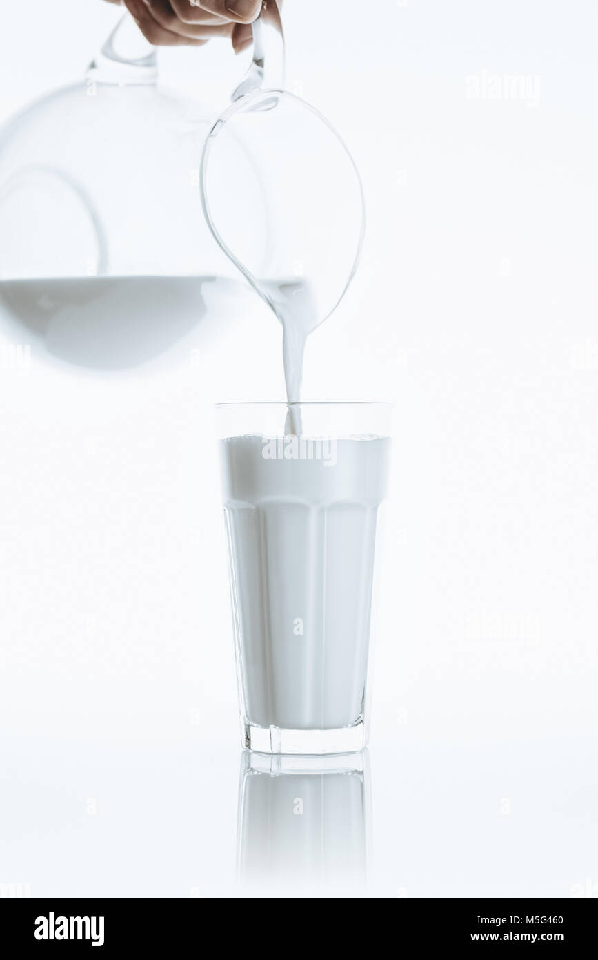 pouring milk from jar into glass Stock Photo - Alamy