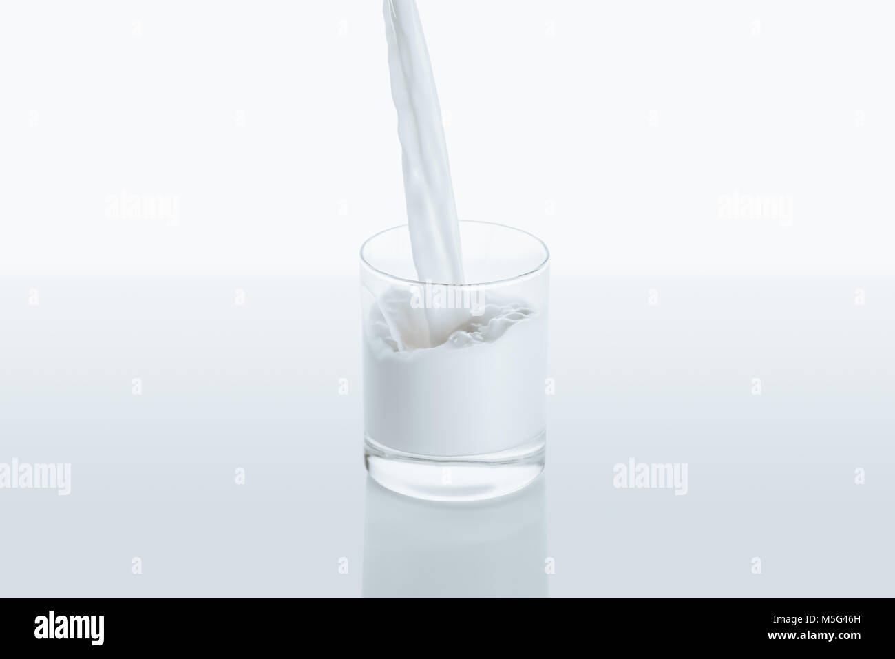 milk pouring into glass Stock Photo - Alamy