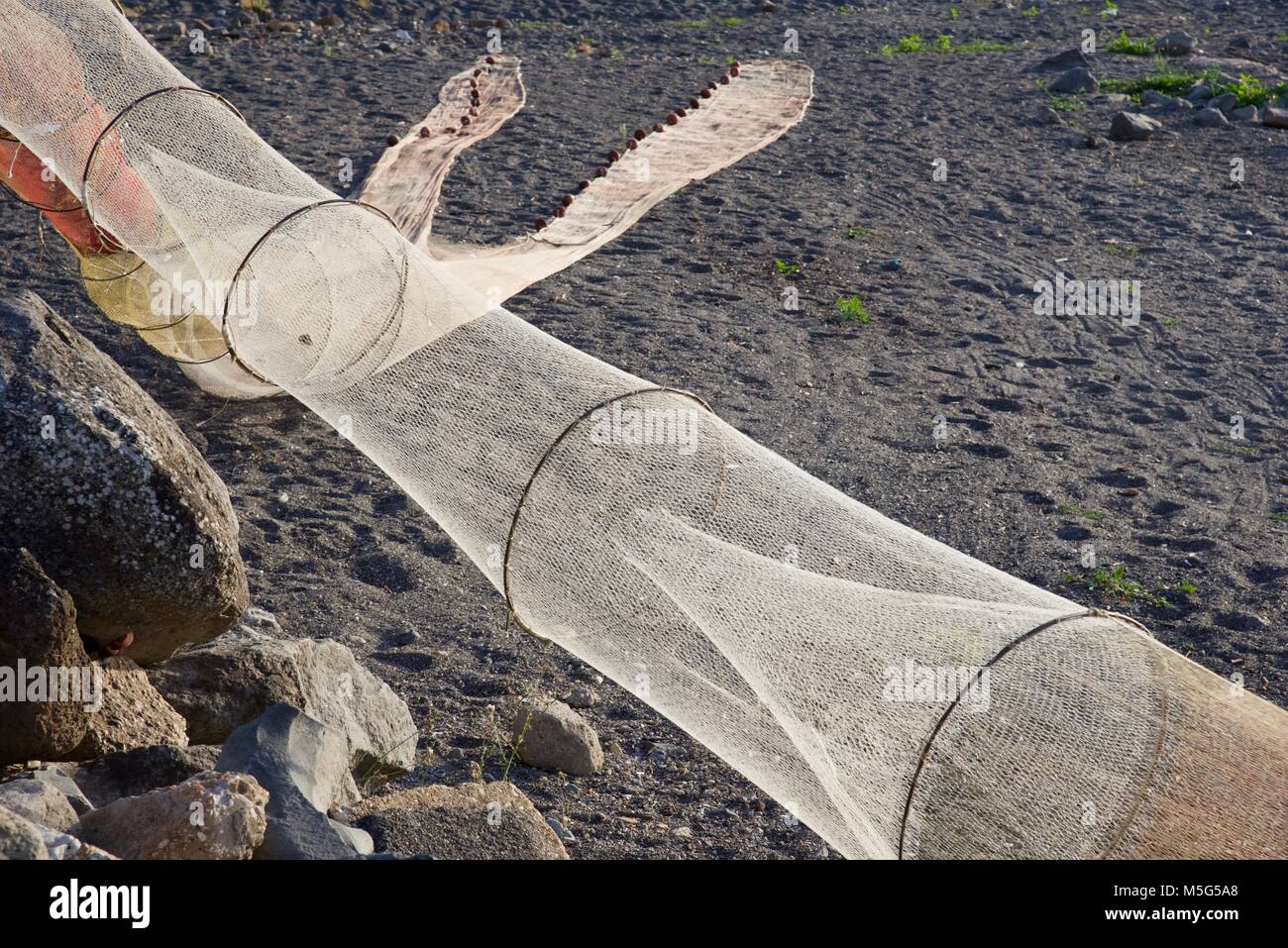 Fishing net on a sand beach Stock Photo - Alamy