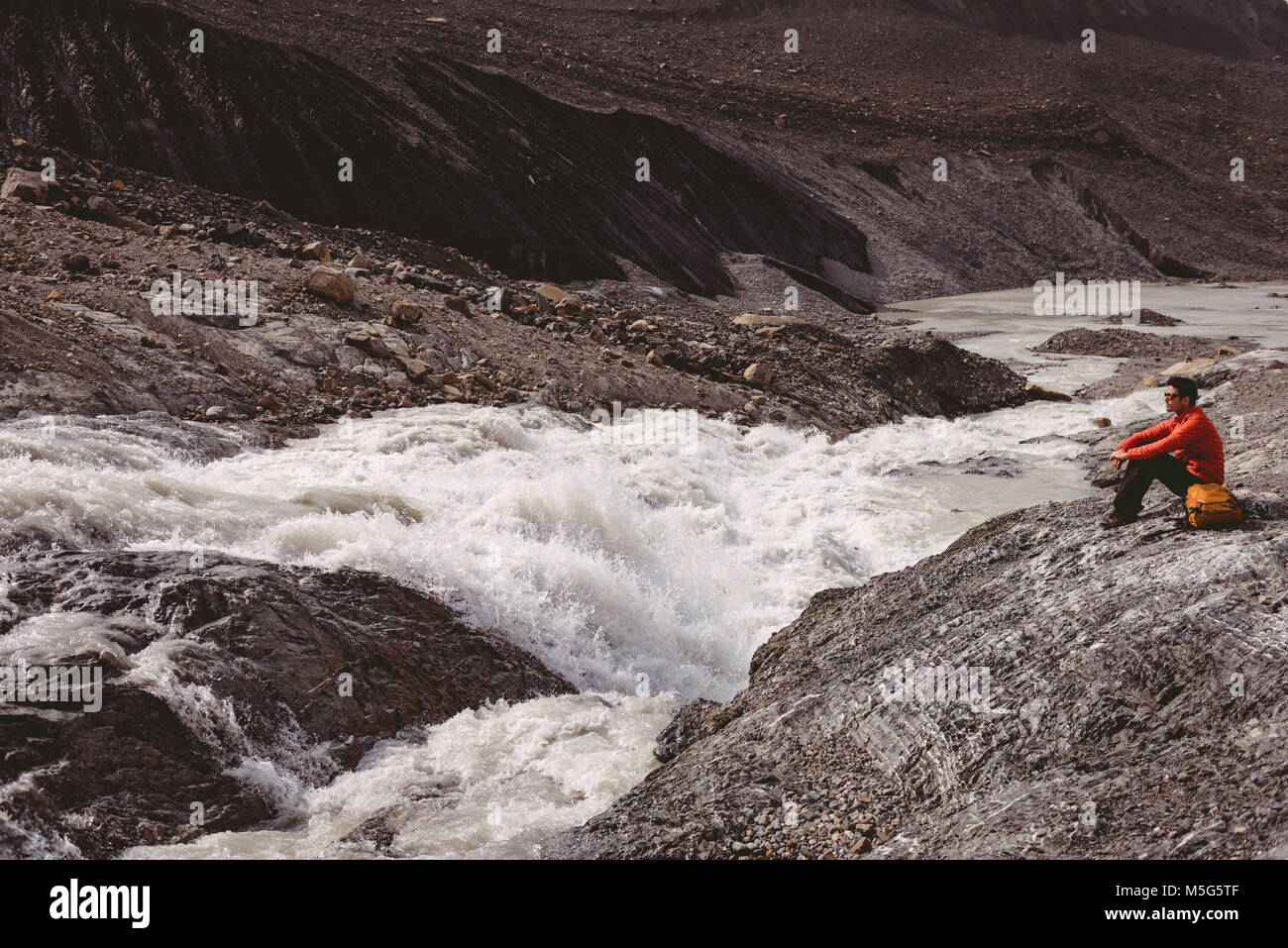 Male hiker relaxing near river Stock Photo - Alamy