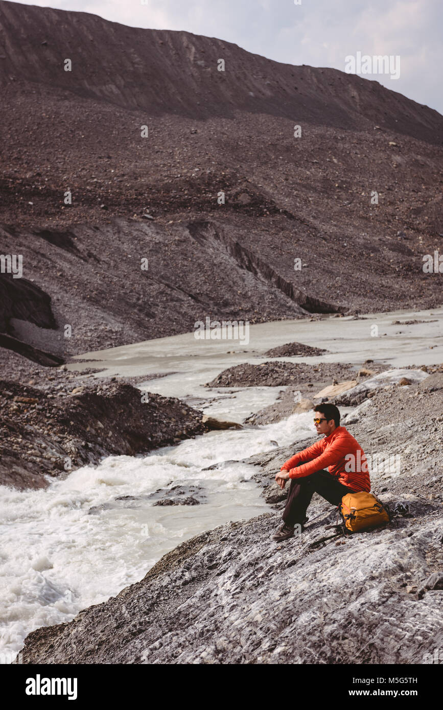 Male hiker relaxing near river Stock Photo - Alamy