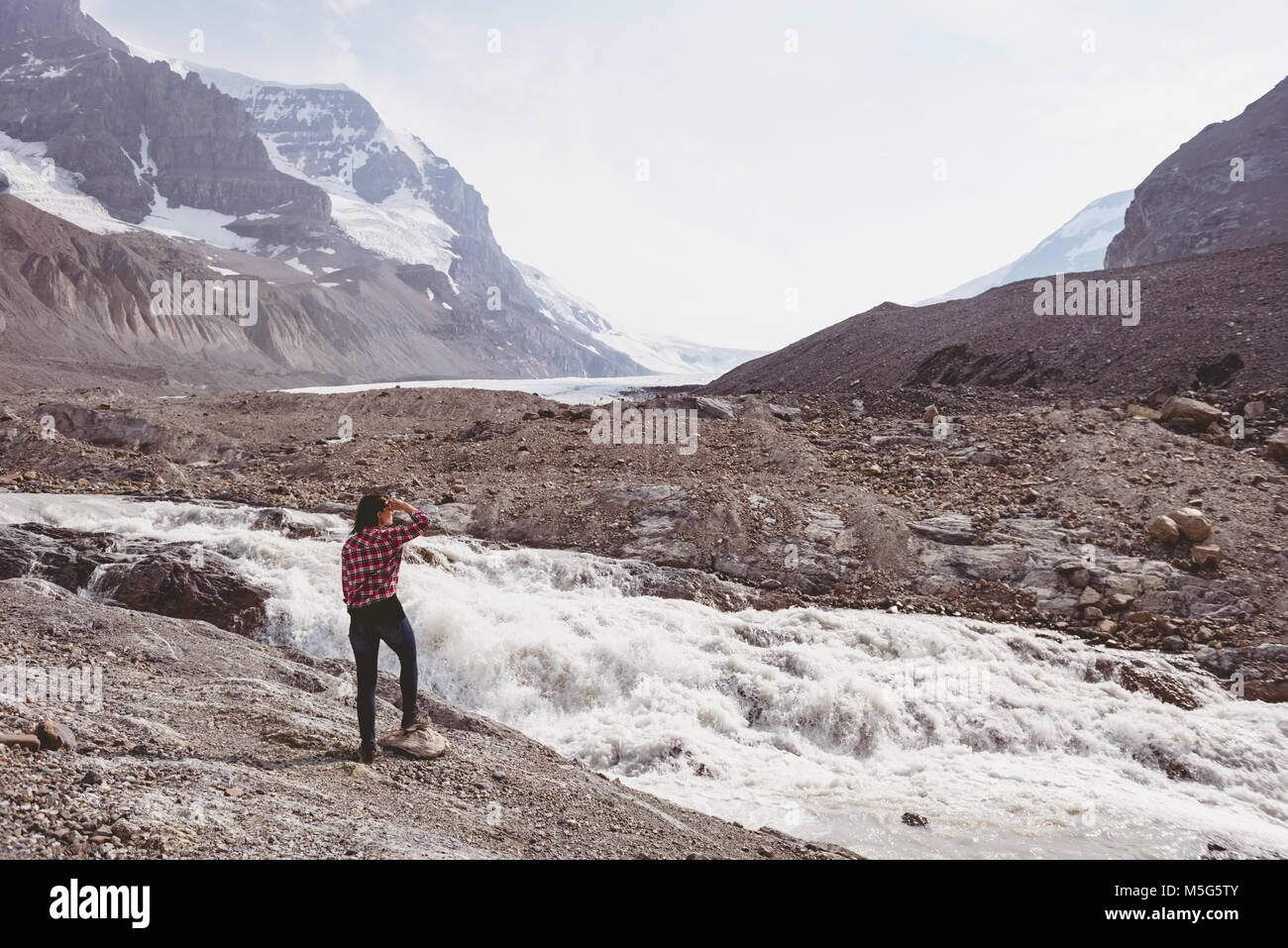 Woman standing near river Stock Photo - Alamy