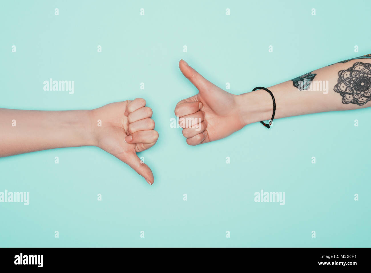 cropped shot of women showing thumbs up and down signs isolated on ...