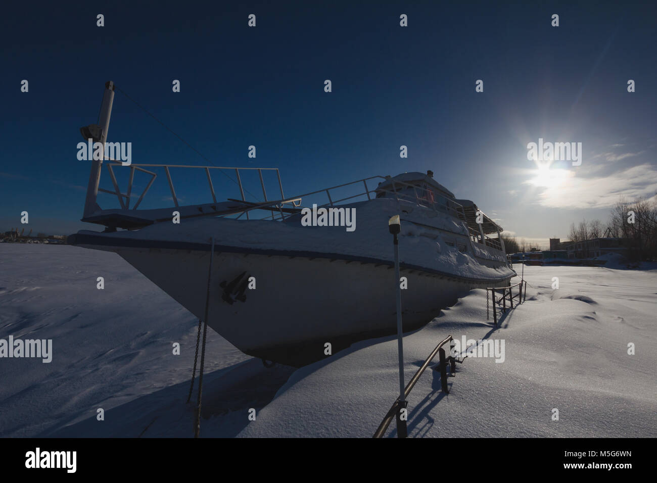 Frozen ship staying on river covered ice at winter sunny day Stock ...