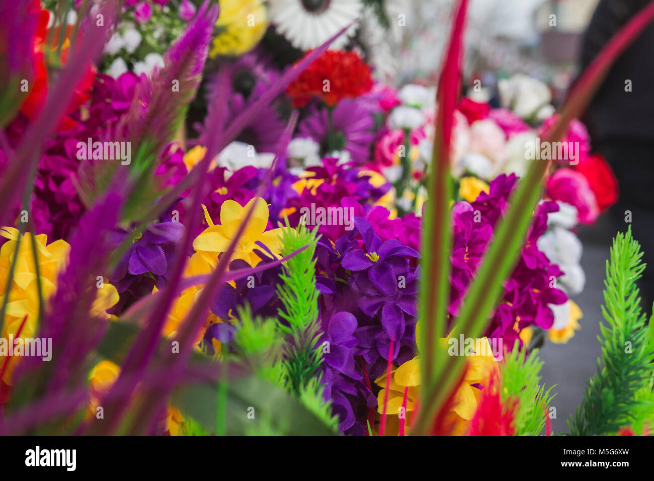 Various color plastic flowers Stock Photo - Alamy