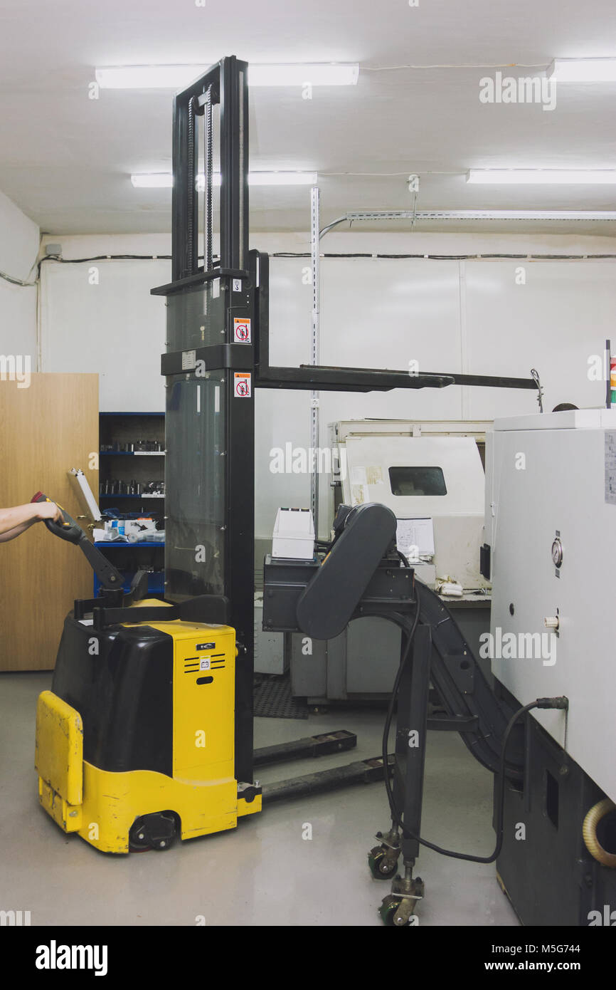 Warehouse forklift stacker loader stacking cardboxes in metal industry ...