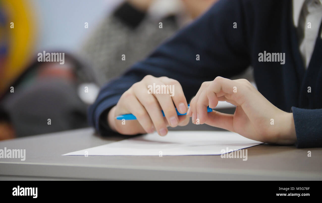 Classmates in classroom during the lesson - hands holding pen Stock ...