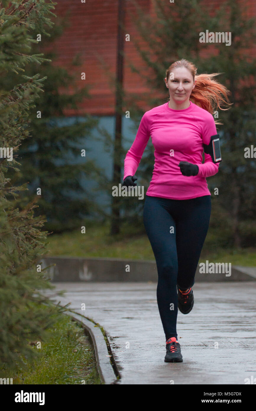 Woman in pink running in autumn park. Female runner outdoor, Healthy ...