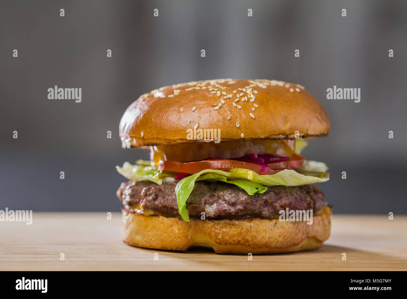 A large tasty burger on table Stock Photo - Alamy