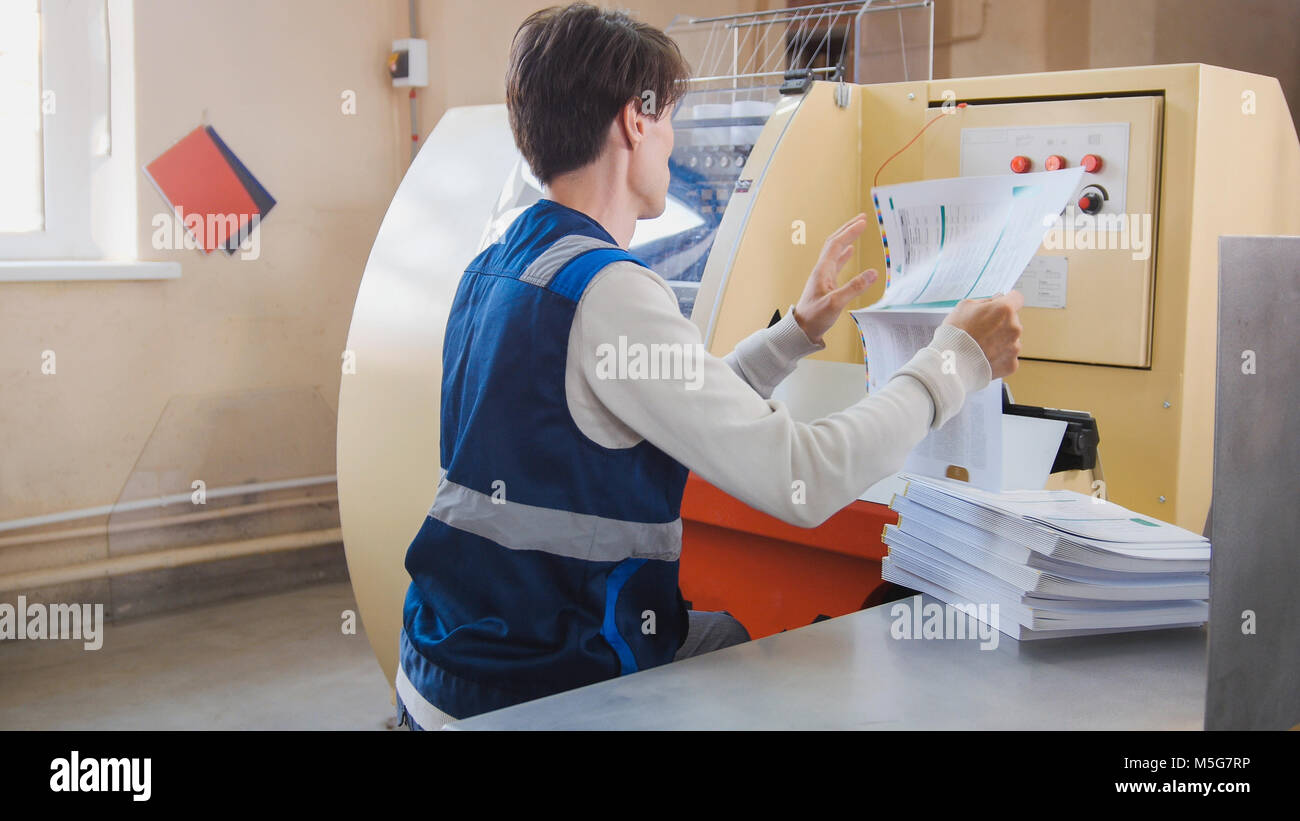 The print operator puts a sheet of paper Stock Photo - Alamy