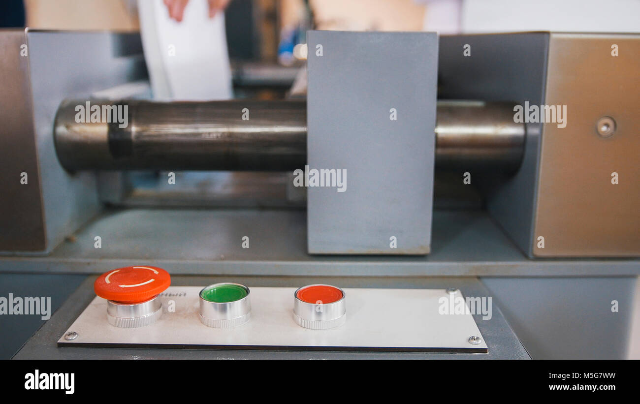 Red button on control panel of folding machine - printing polygraph ...