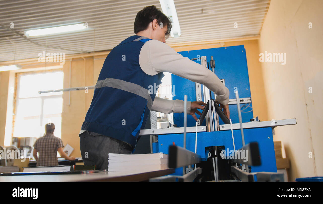 The print operator puts a sheet of paper Stock Photo - Alamy