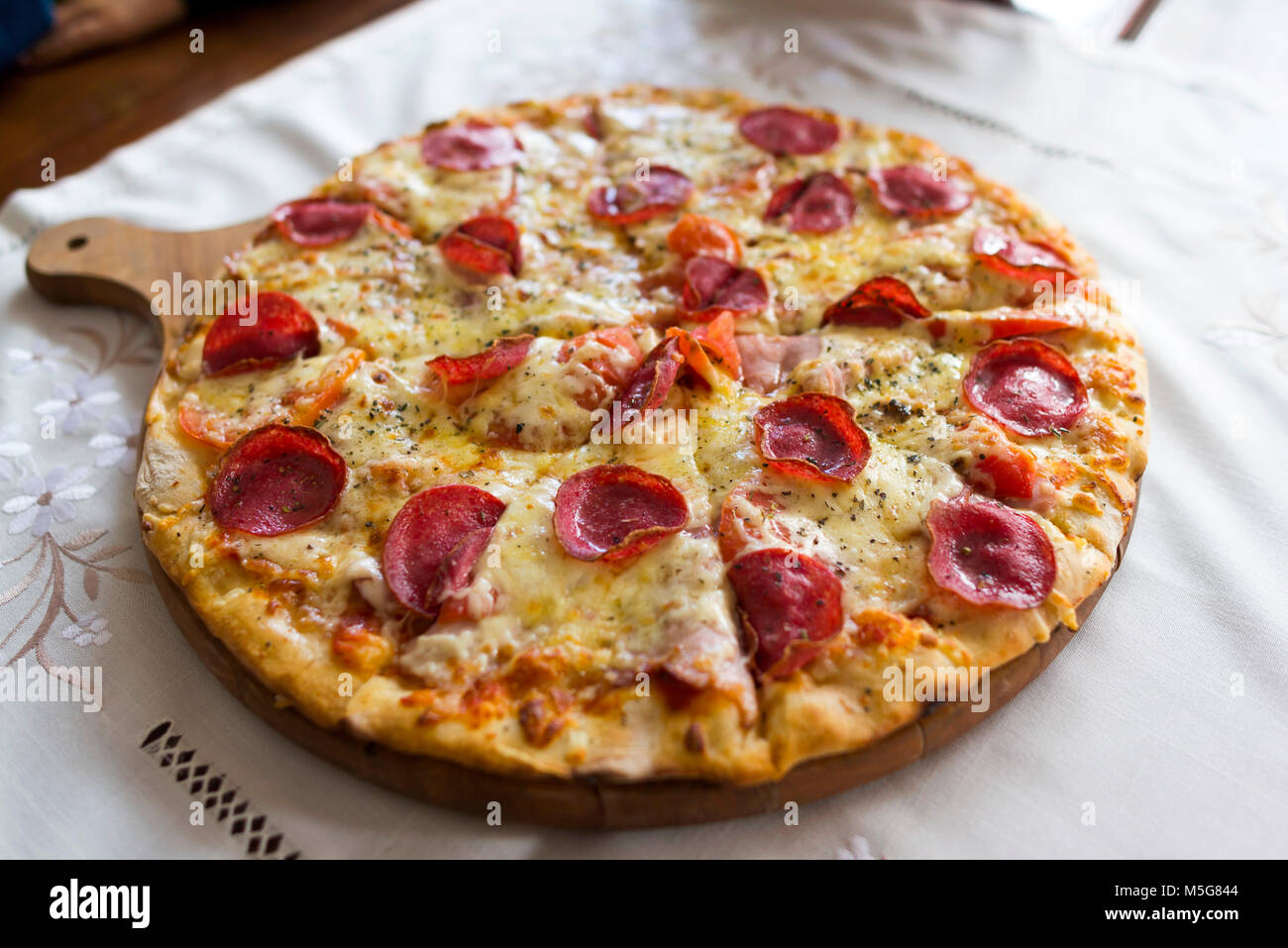 Pizza on desk - focus selected, natural light Stock Photo - Alamy
