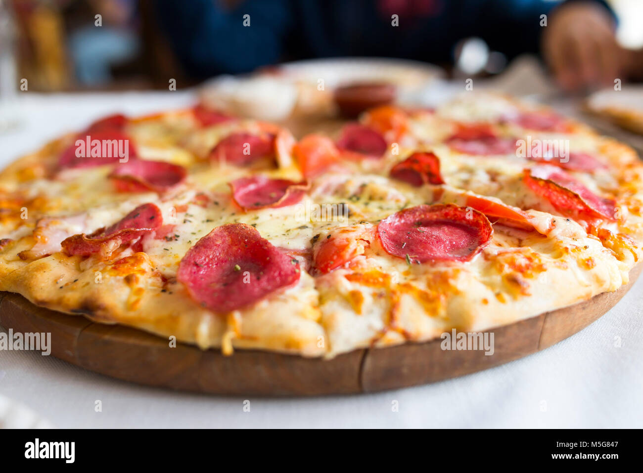 Pizza on desk - focus selected, natural light Stock Photo - Alamy