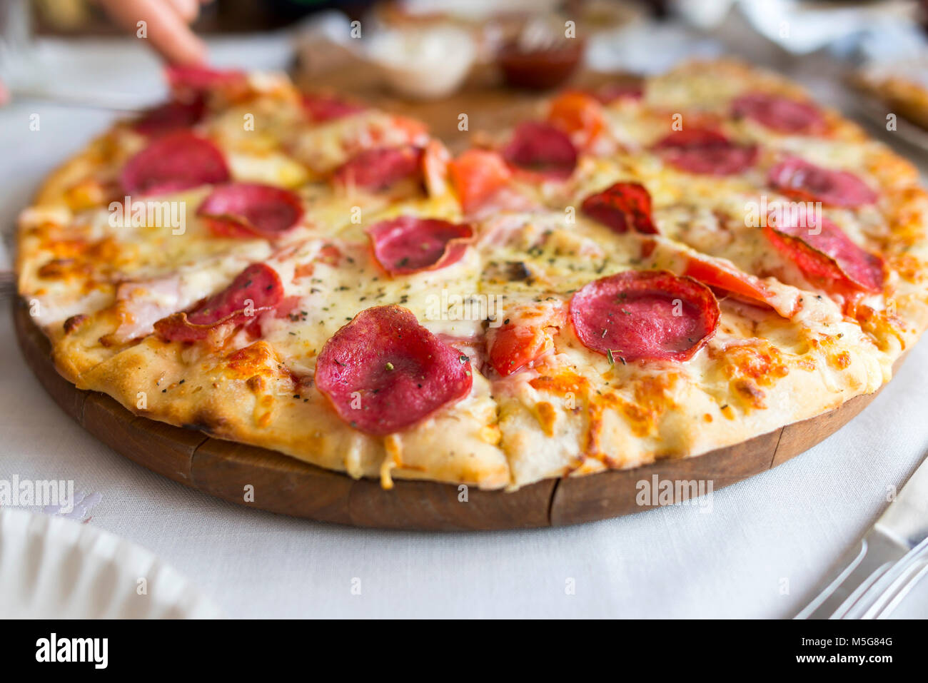 Pizza on desk - focus selected, natural light Stock Photo - Alamy