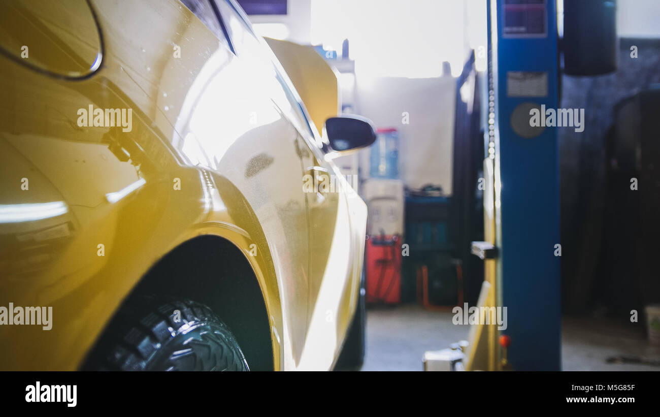 Yellow car in garage auto service - diagnostics and repairing Stock ...