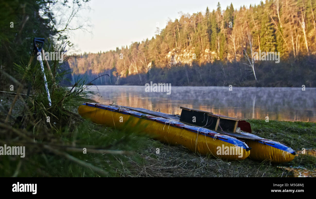 Raft on shore of mountain misty forest river Stock Photo - Alamy