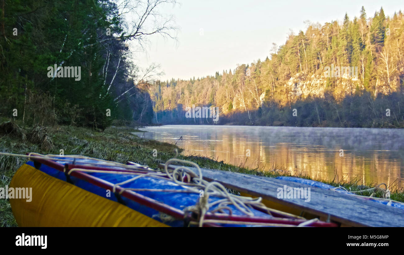 Raft on shore of mountain misty river Stock Photo - Alamy