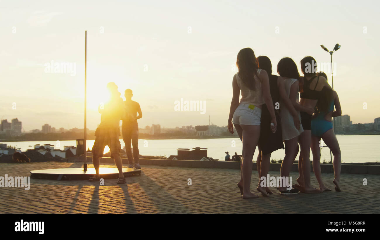 The photographer photographing group of beautiful girl at sunset Stock ...