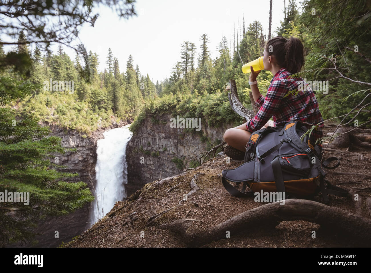 Woman sitting near waterfall hi-res stock photography and images - Alamy