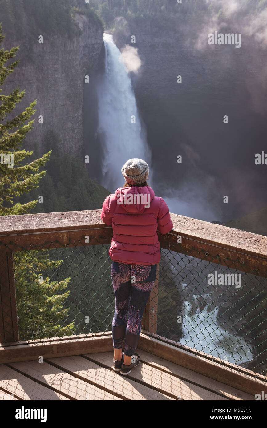 Woman looking at waterfall Stock Photo - Alamy