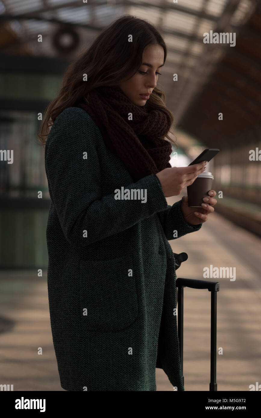 Woman train station platform phone bag hi-res stock photography and ...