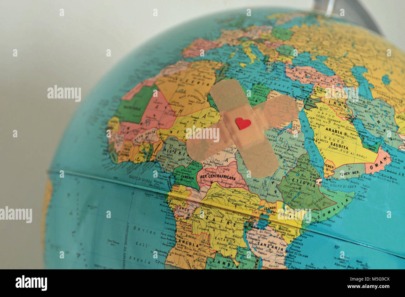 World with plaster with heart - Solidarity and aid to countries in need ...