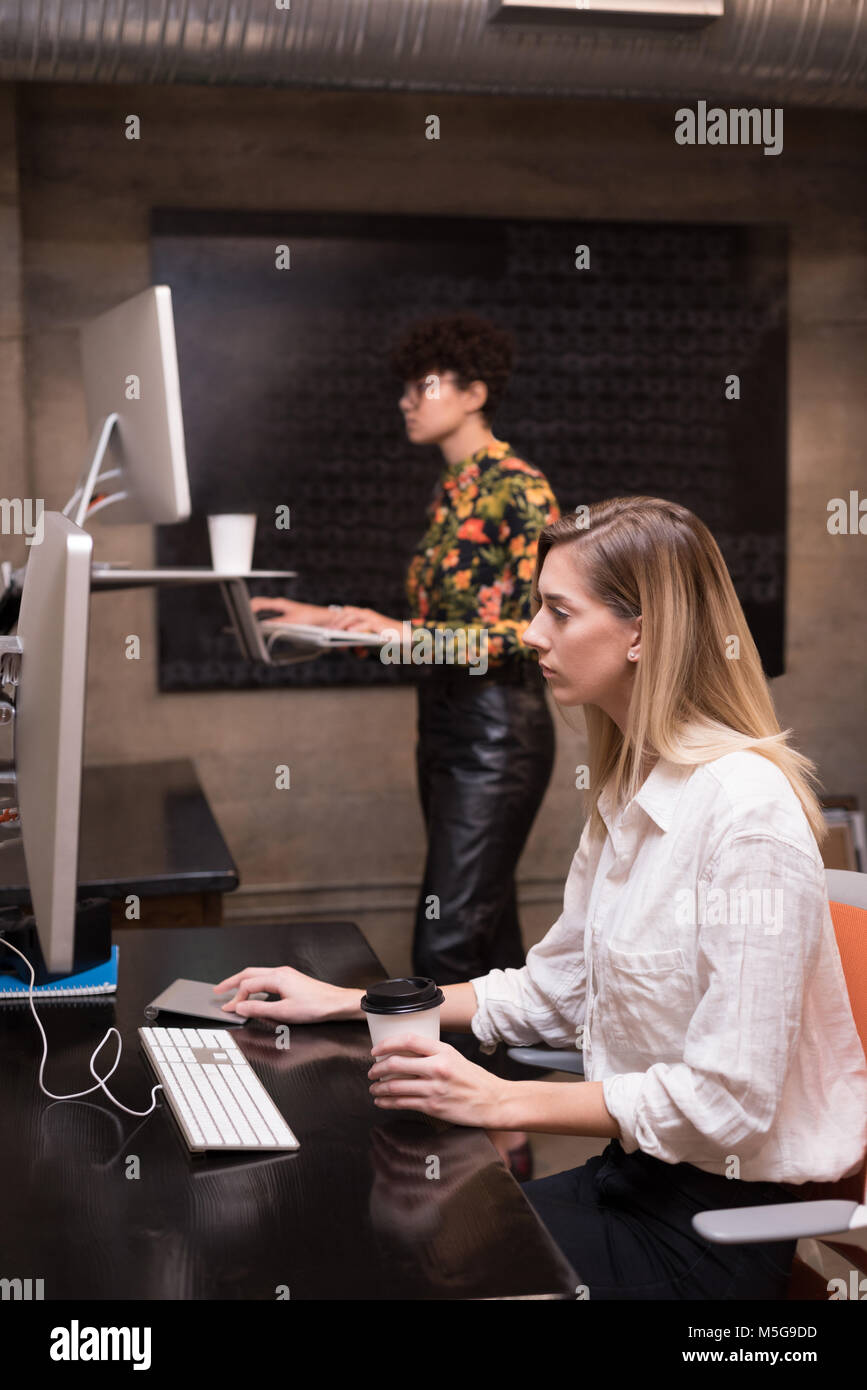 Female executives working on computer Stock Photo - Alamy