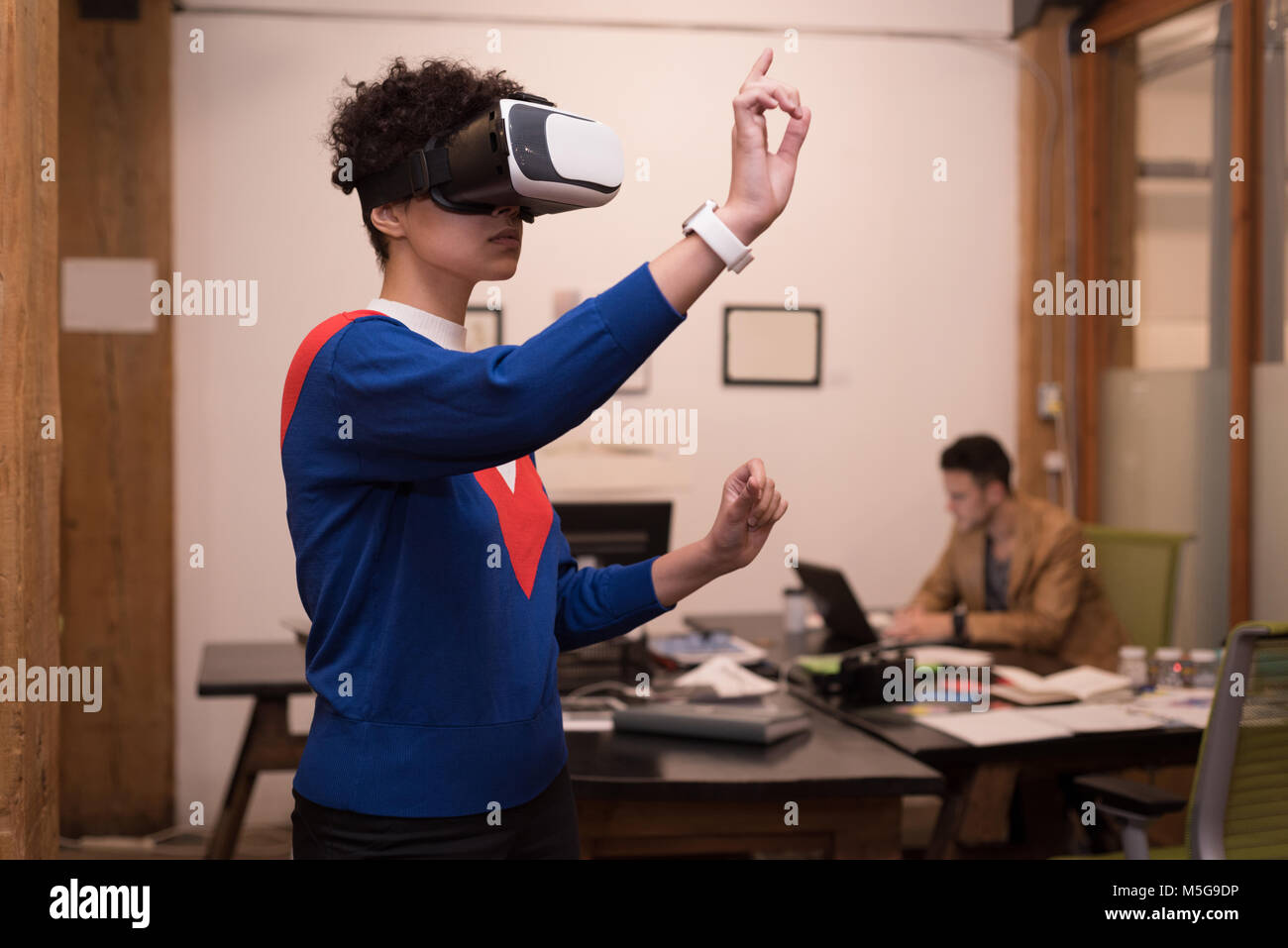 Female executive using virtual reality headset Stock Photo - Alamy