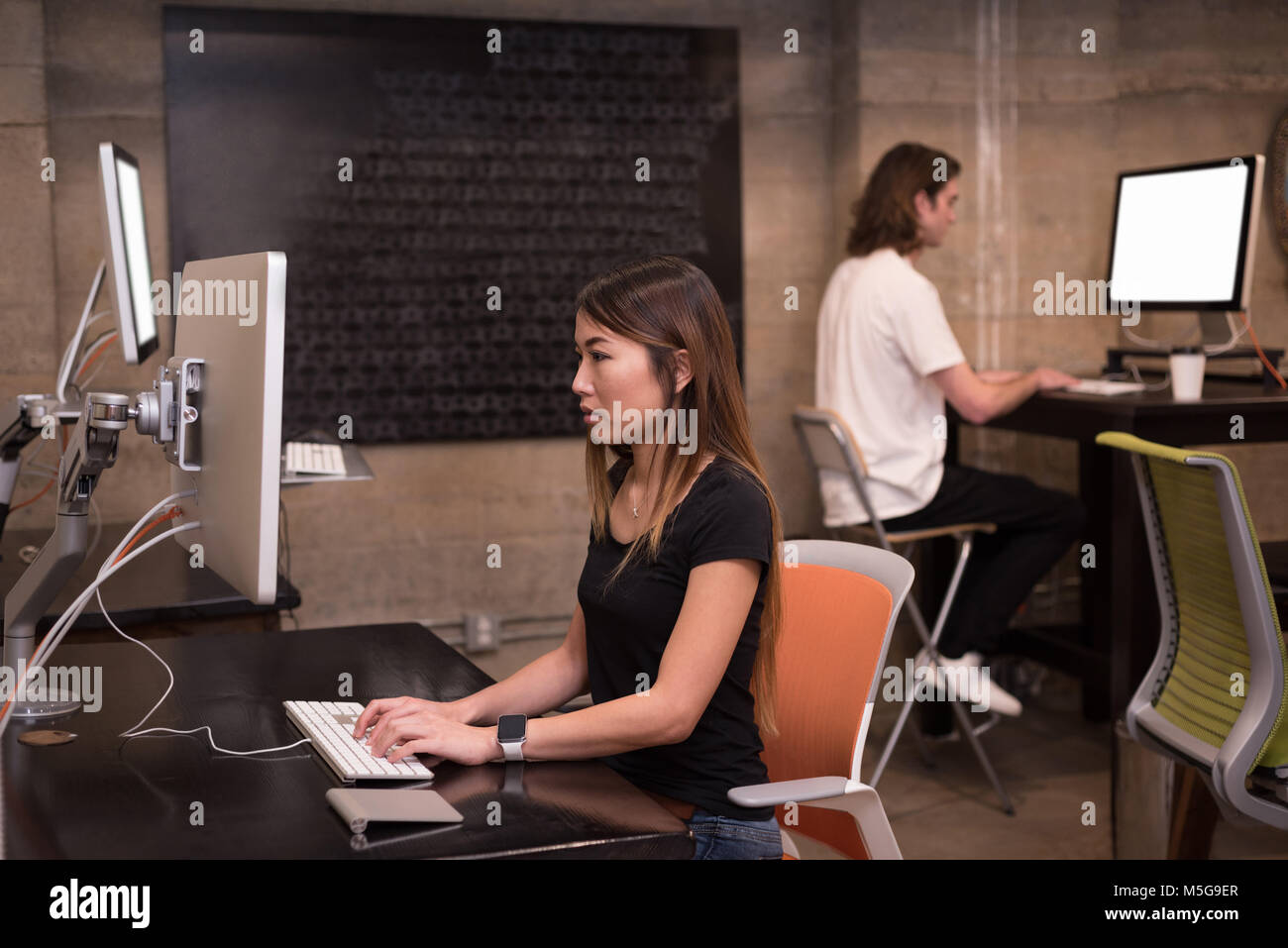 Business colleagues working on computer at desk Stock Photo - Alamy