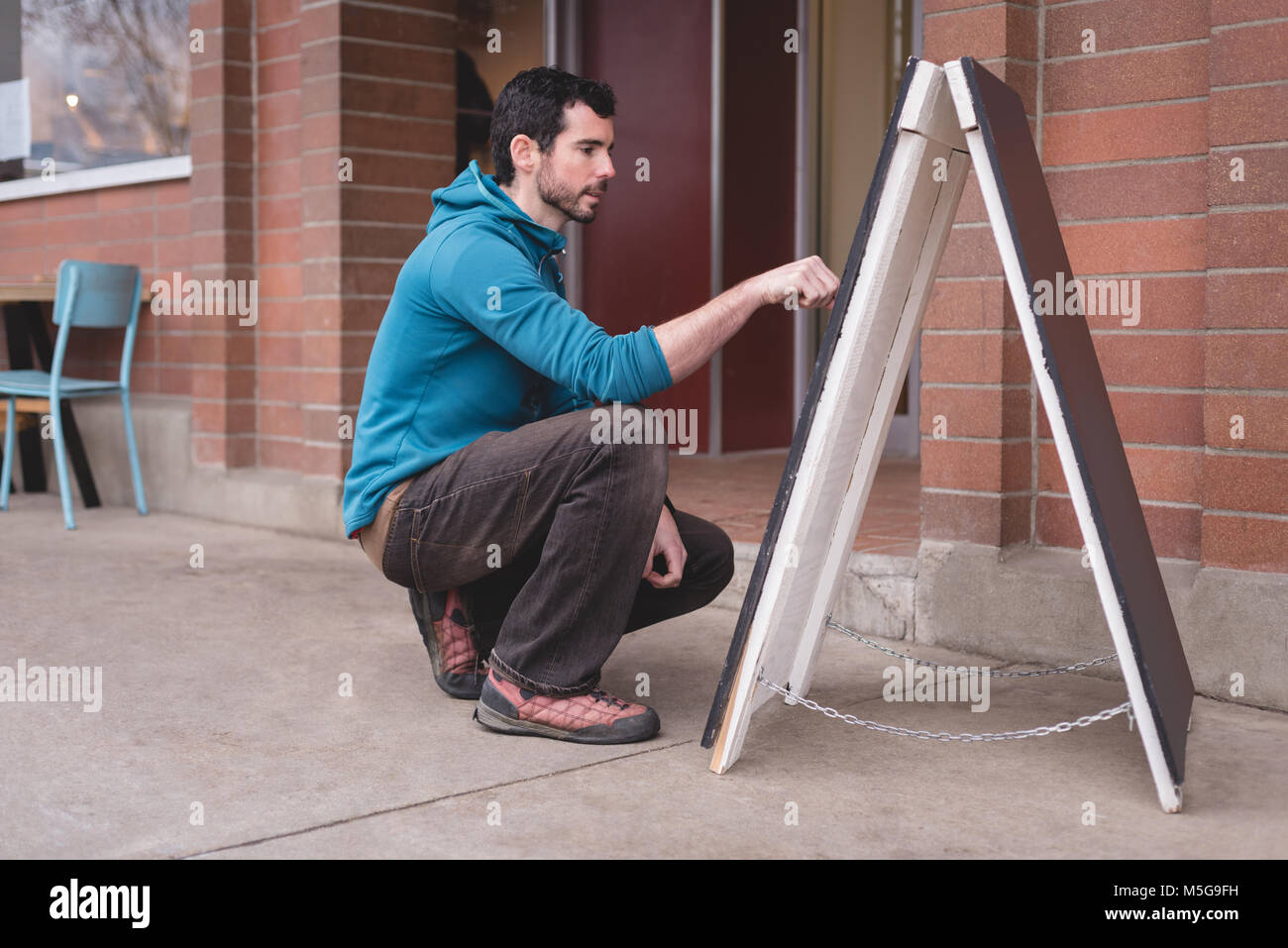 Man looking at menu board Stock Photo - Alamy