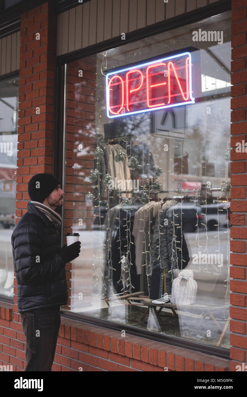 Man looking at window display of shop Stock Photo - Alamy