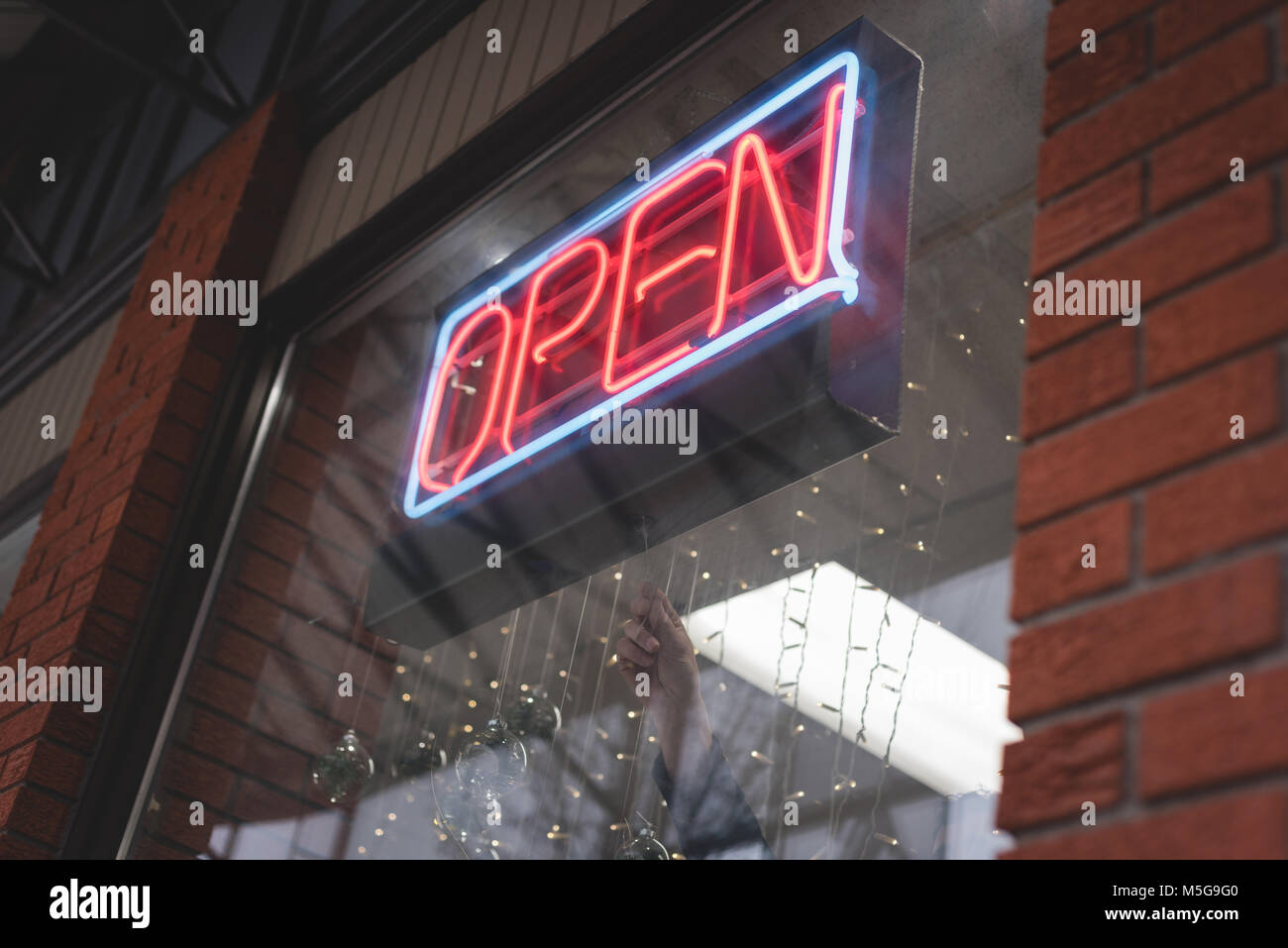 Shop with open sign with neon light Stock Photo - Alamy
