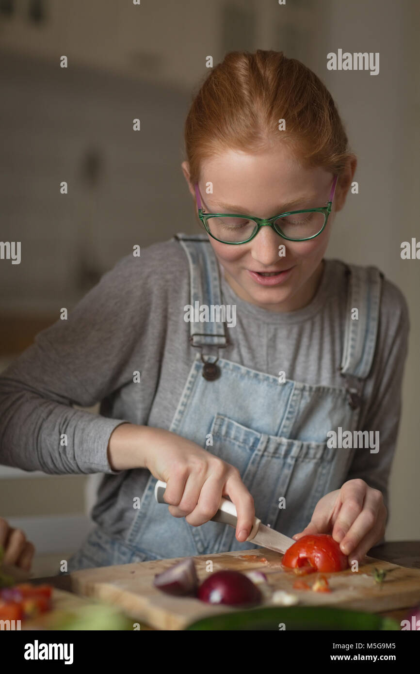 Girl cutting vegetables in kitchen Stock Photo - Alamy
