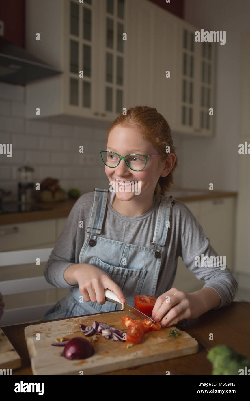 Girl cutting vegetables in kitchen Stock Photo - Alamy