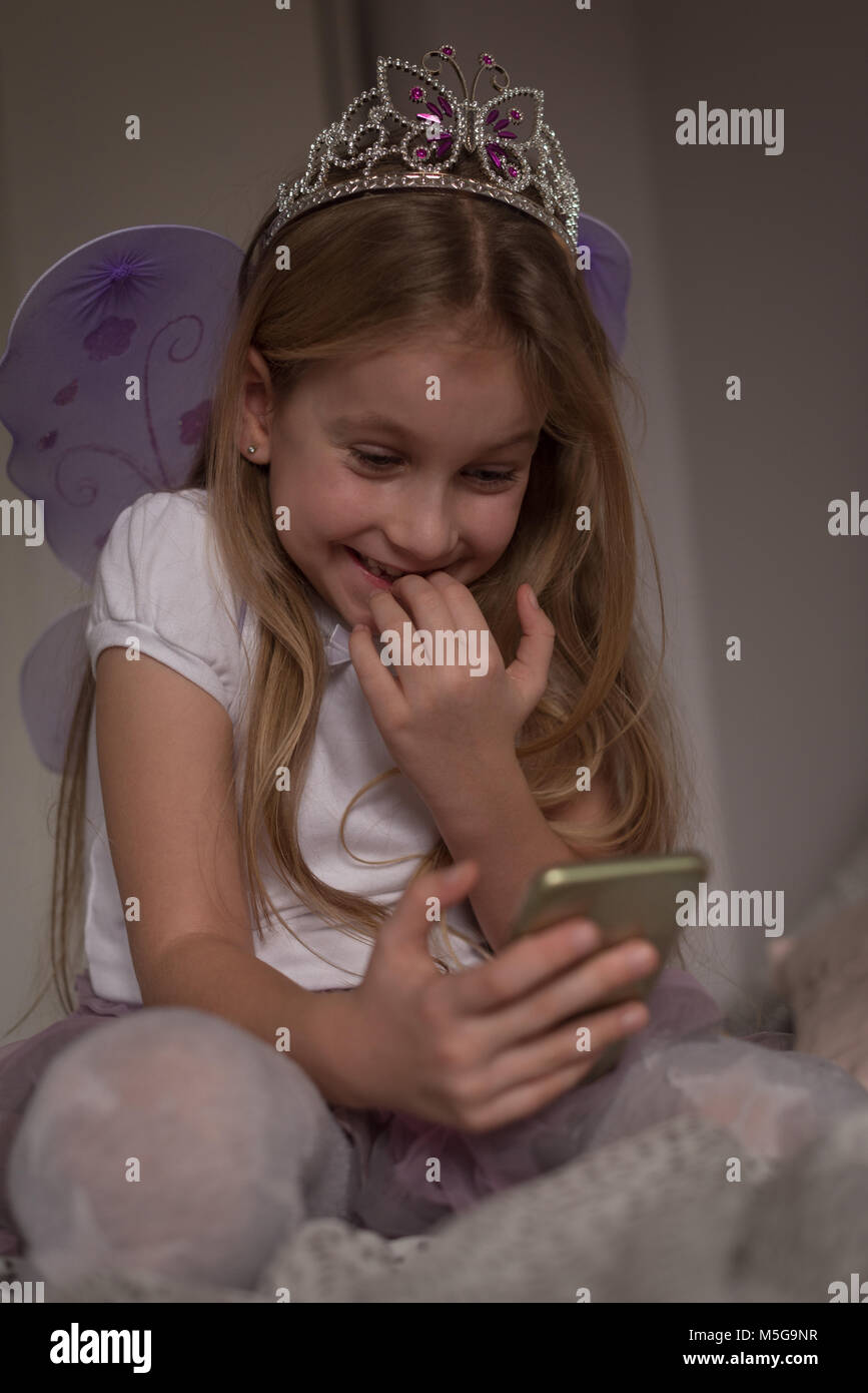 Girl using mobile phone in bedroom Stock Photo - Alamy