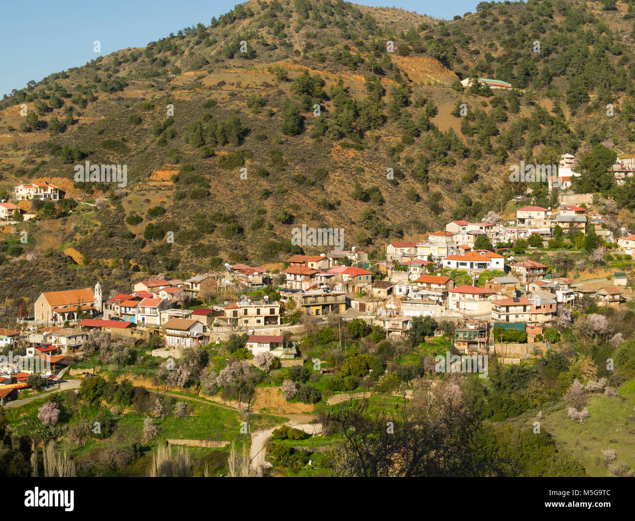 View across to tranquil and picturesque hillside Oikos Village in the ...
