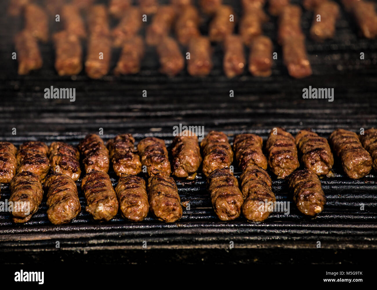 Grilled minced meat rolsls called Mici in traditional Romanian cuisine ...